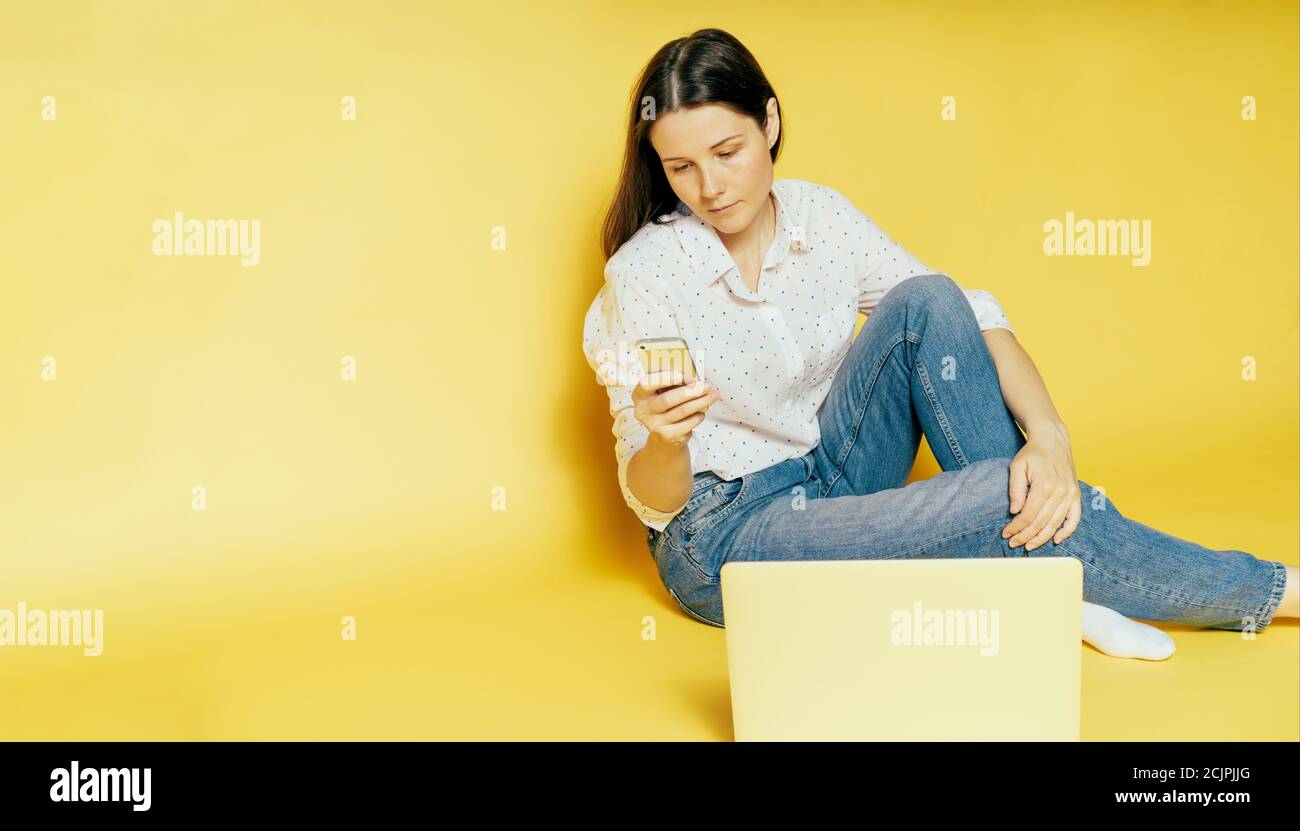 woman looks intently at the phone screen Stock Photo - Alamy