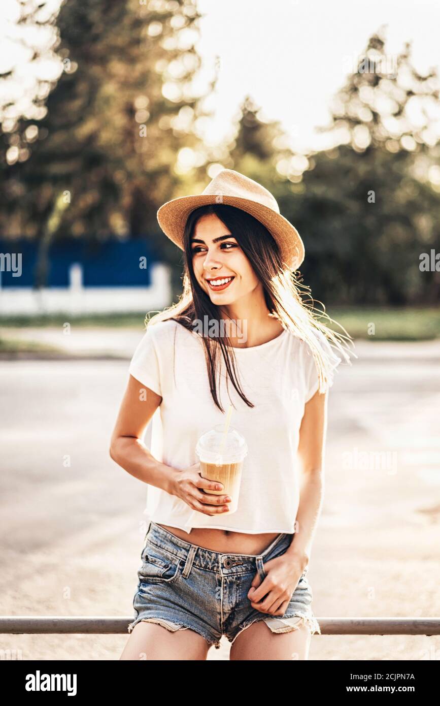 Pretty brunette tourist girl with cup of cold coffee outdoor Stock ...