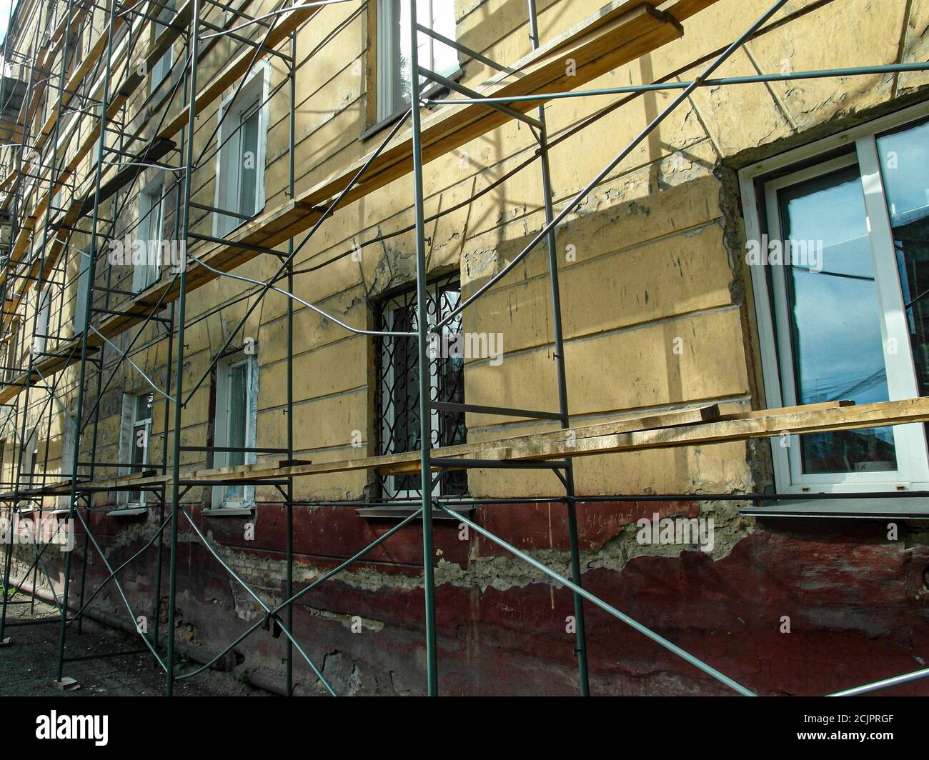 building preparing for repair with scaffolding stands along the wall ...