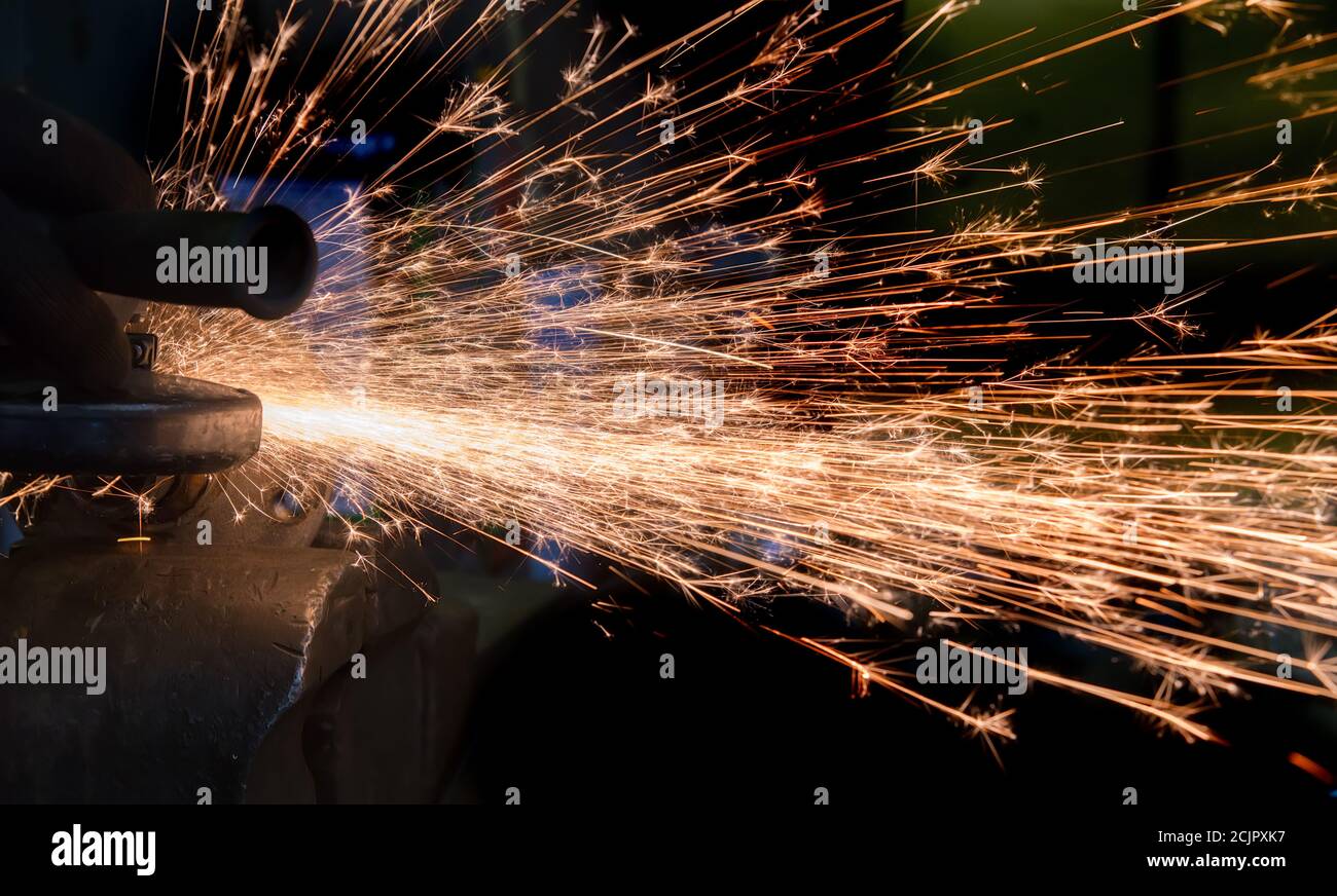 sparks from metal polishing by the grinder Stock Photo - Alamy