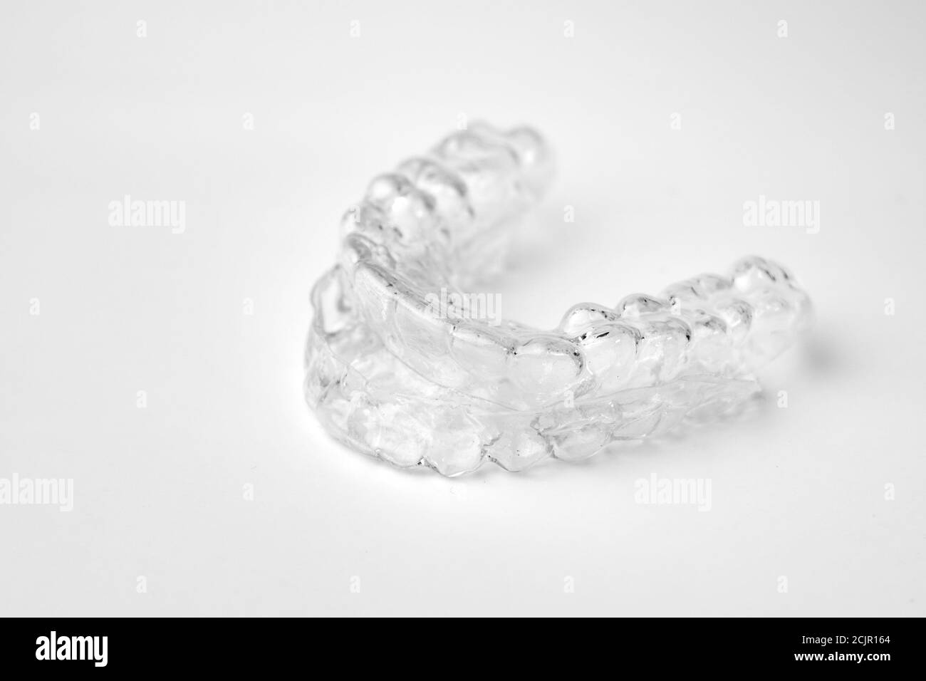Invisible orthodontic removable braces on a white background with copy ...