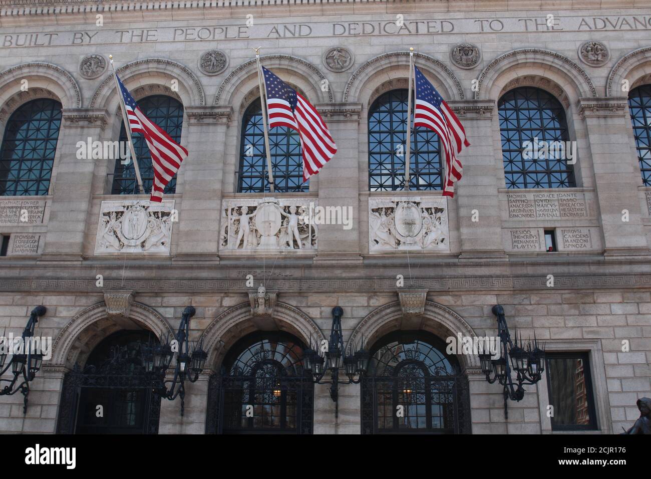 Three American flags hanging above the entrance doors of the Central ...