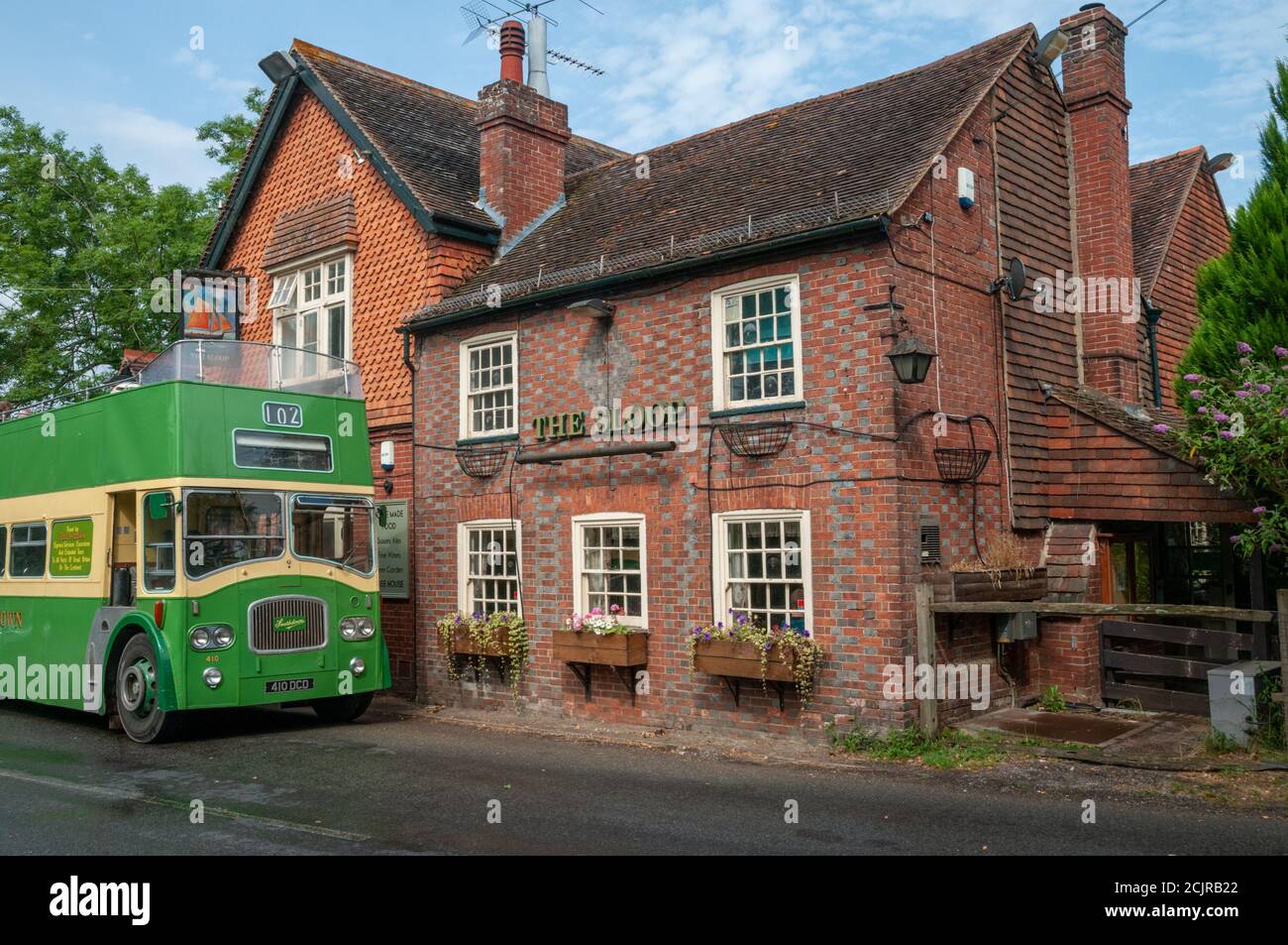 The Sloop Inn pub with an old green double-decker bus parked outside ...