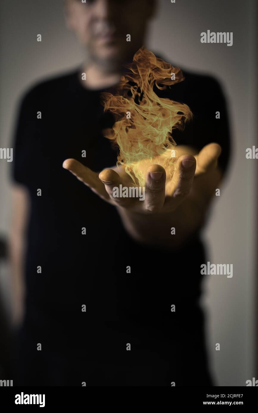 Closeup shot of a male hand with orange flames Stock Photo - Alamy