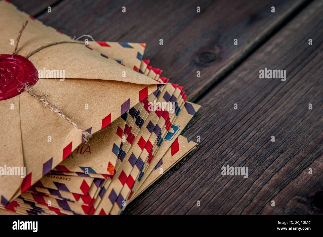 Old letters envelopes with a wax magic stamp triquetra on wooden table ...