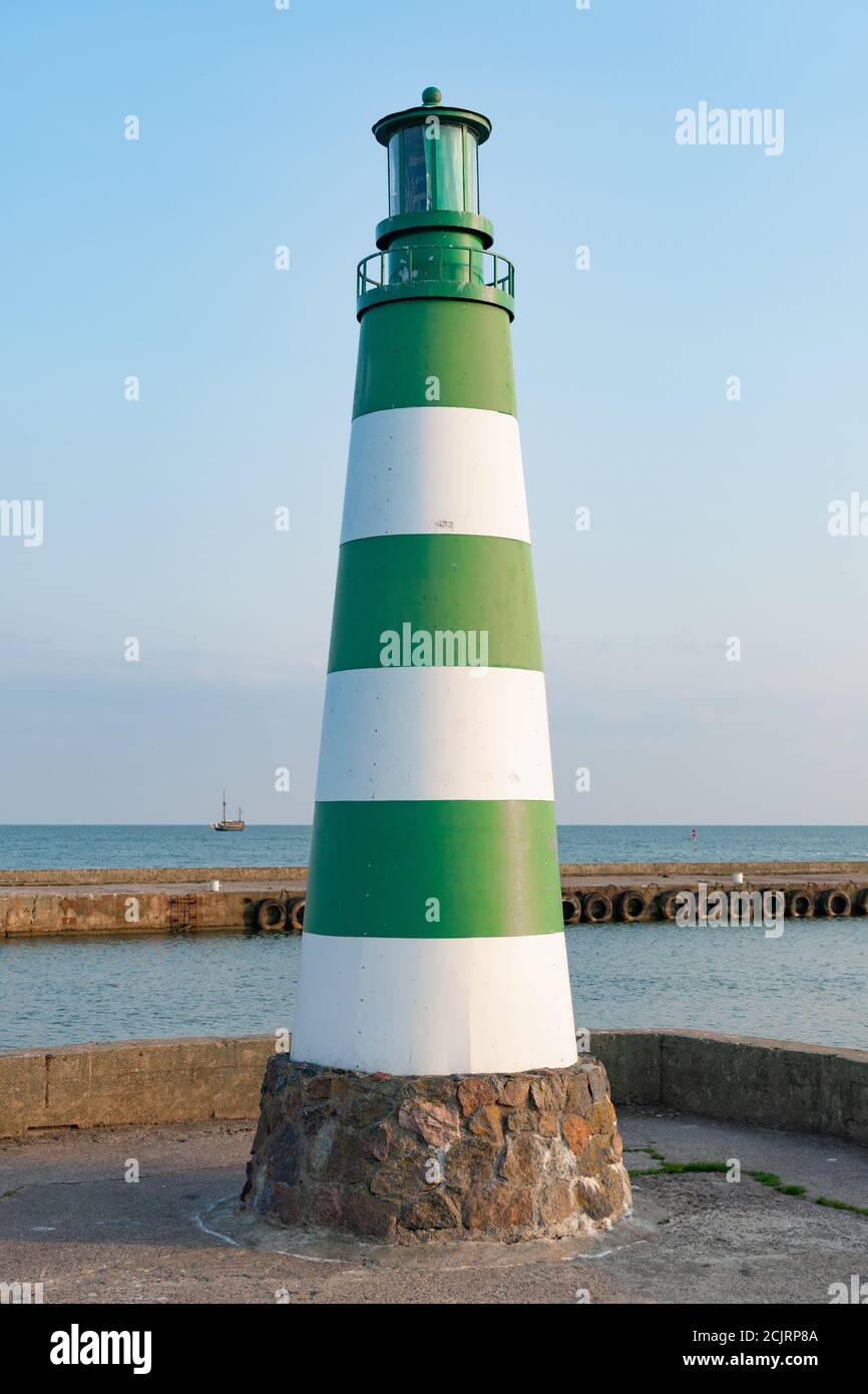 Green and white lighthouse in Nida, Lithuania, vertical Stock Photo - Alamy