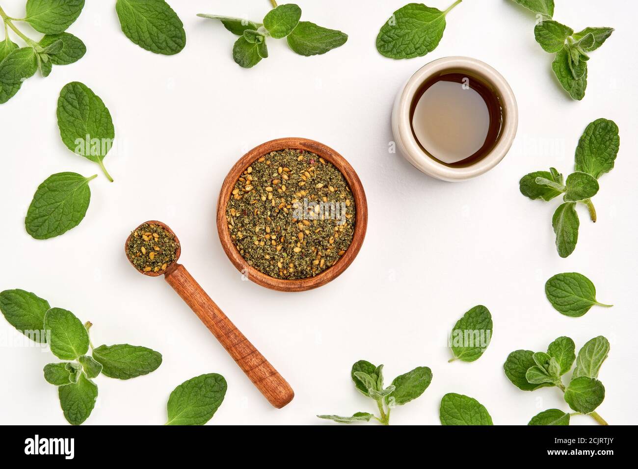 Middle Eastern zaatar spices with fresh zaatar leaves and olive oil ...