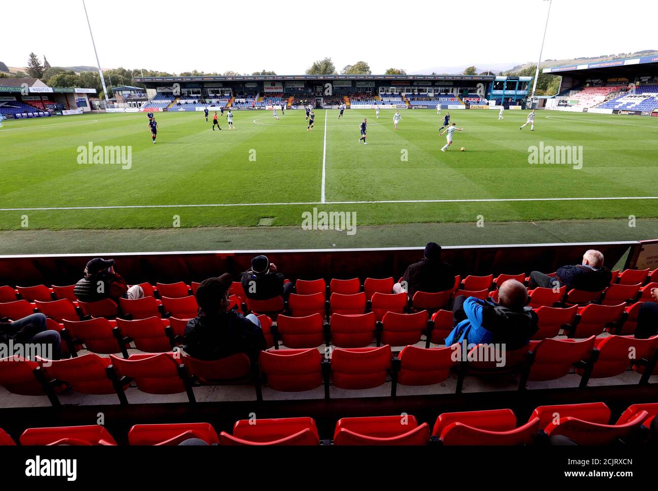 Socially distanced fans in the stands watch the action from the ...
