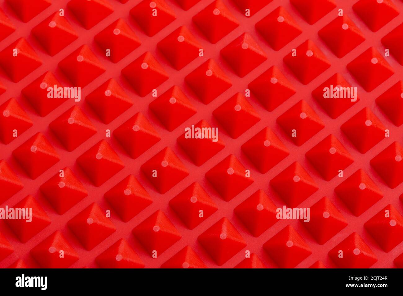 abstract red silicone pyramids array close-up background Stock Photo ...