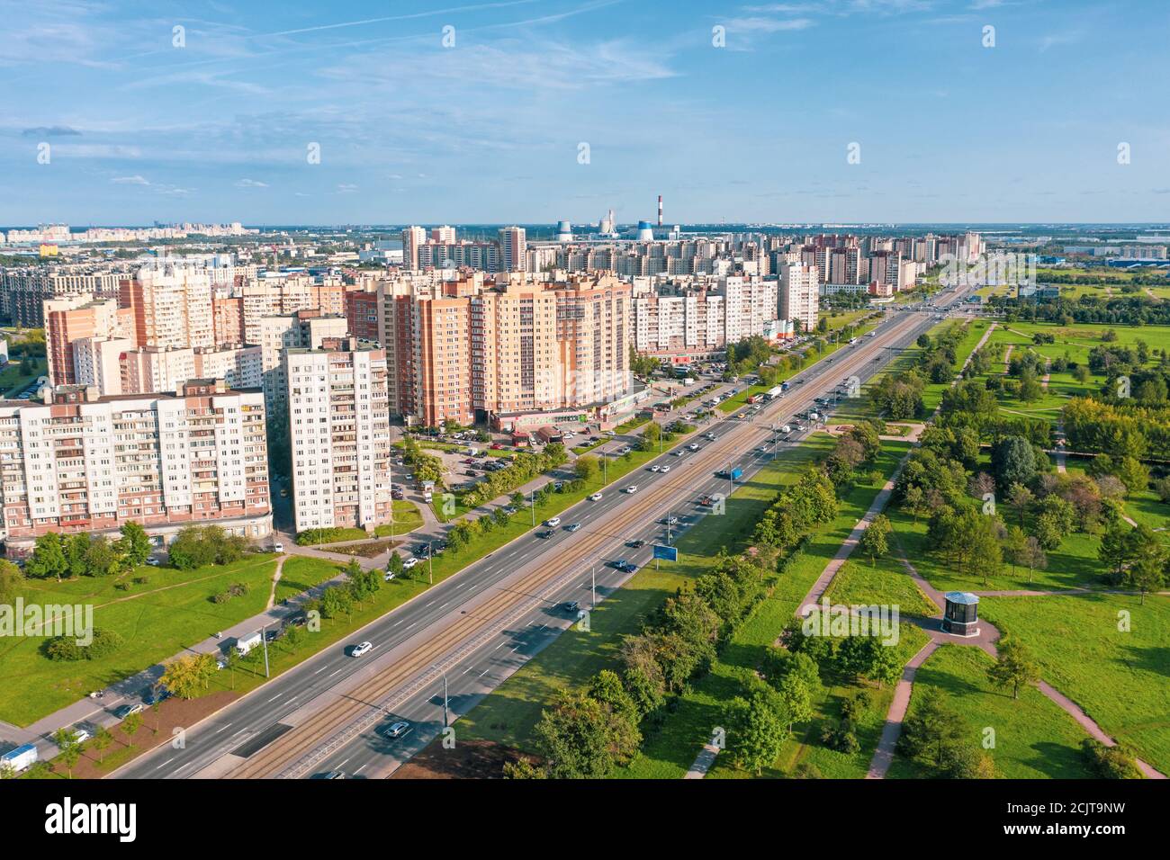 Wide street in the city separating the city park and residential area ...