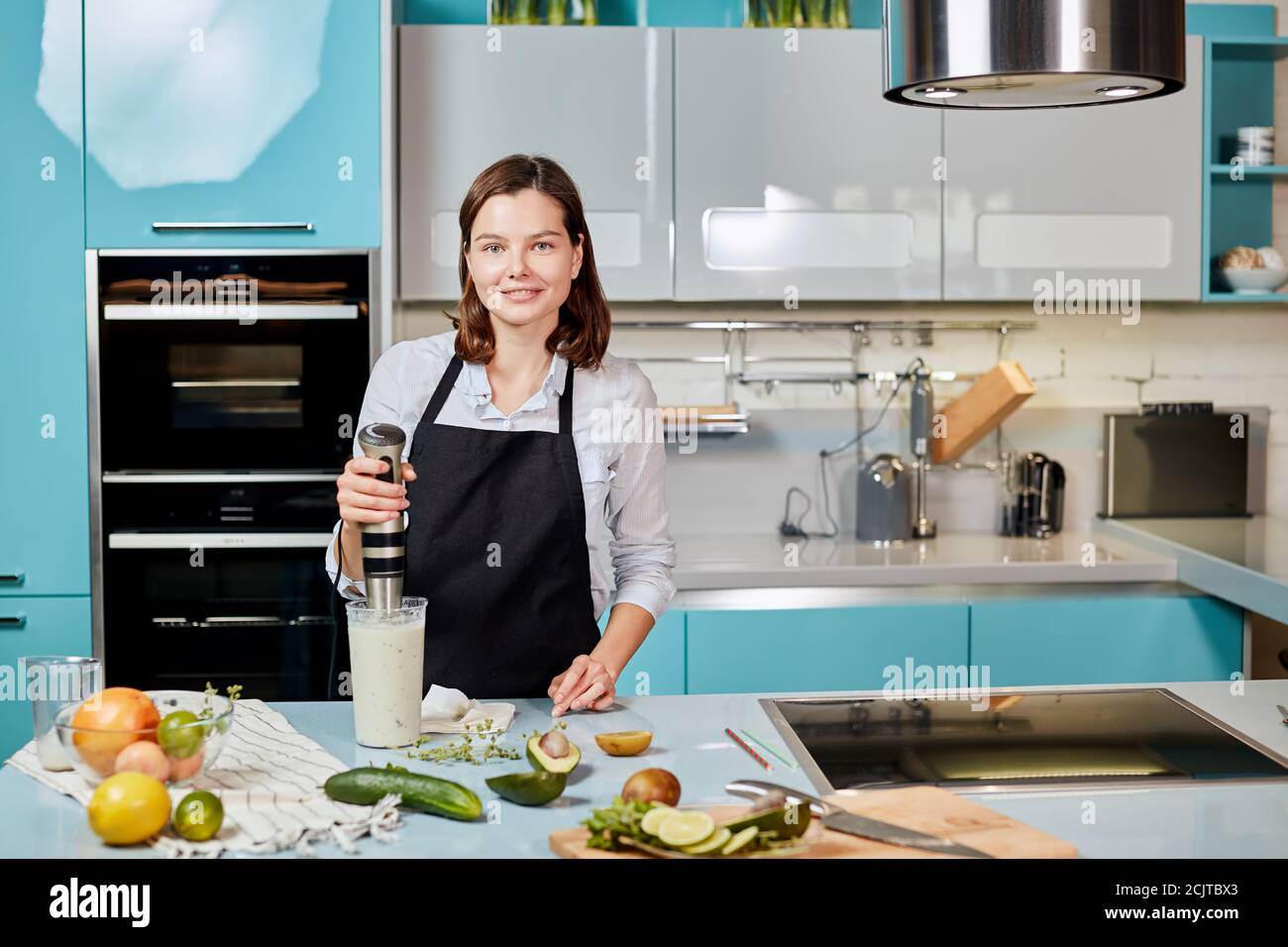 attractive female using blender to make a milkshake indoors Stock Photo ...