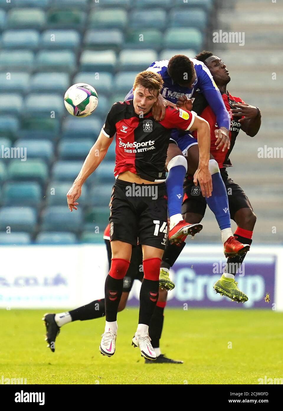 Coventry City's Ben Sheaf and Gillingham's Vadaine Oliver compete for a ...