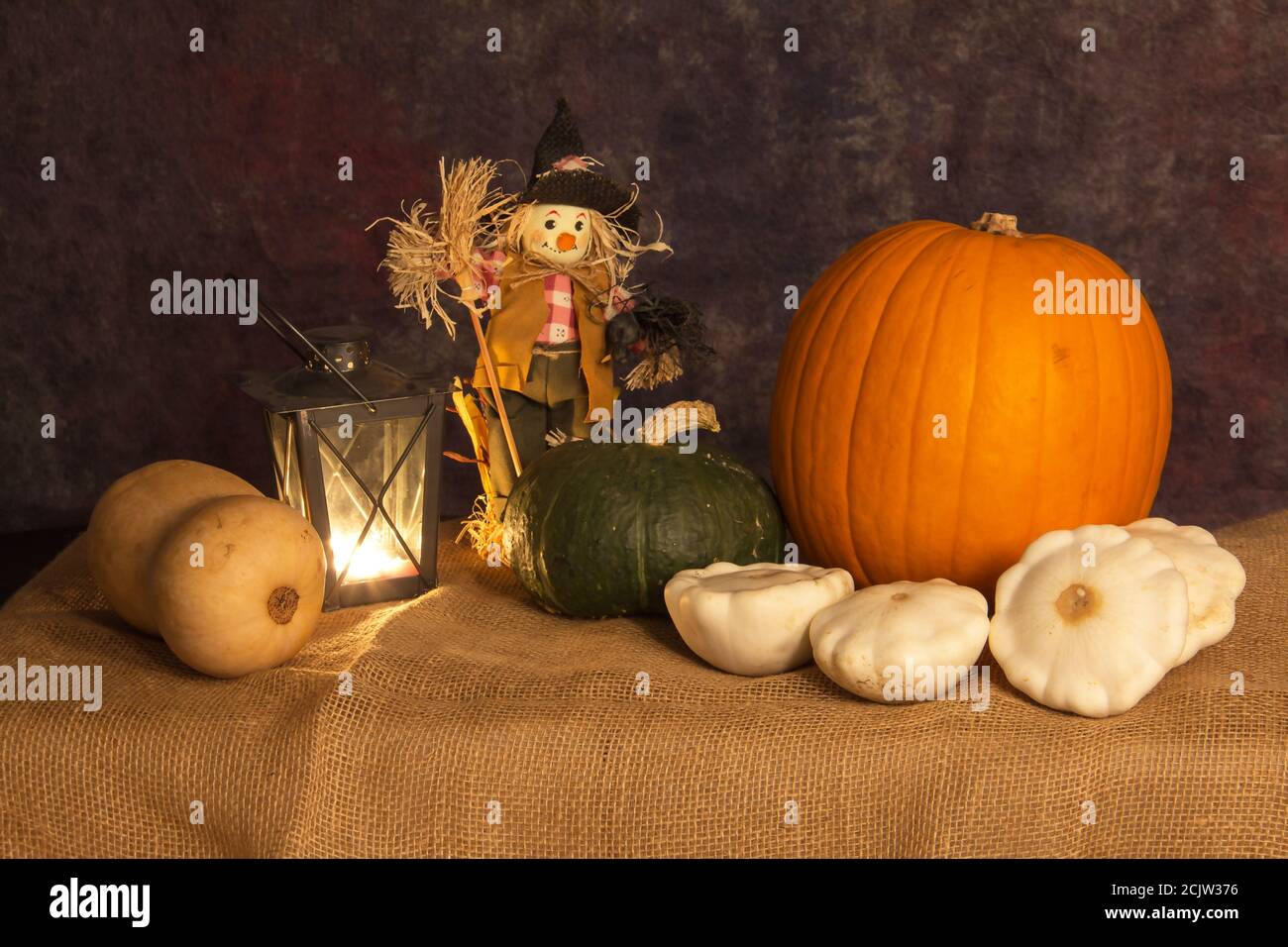 Still life photo of vegetables and a small scarecrow Stock Photo - Alamy