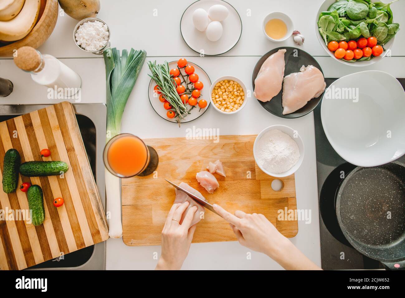 female chopping the meat, chicken.meal with food. cut meat with knife ...