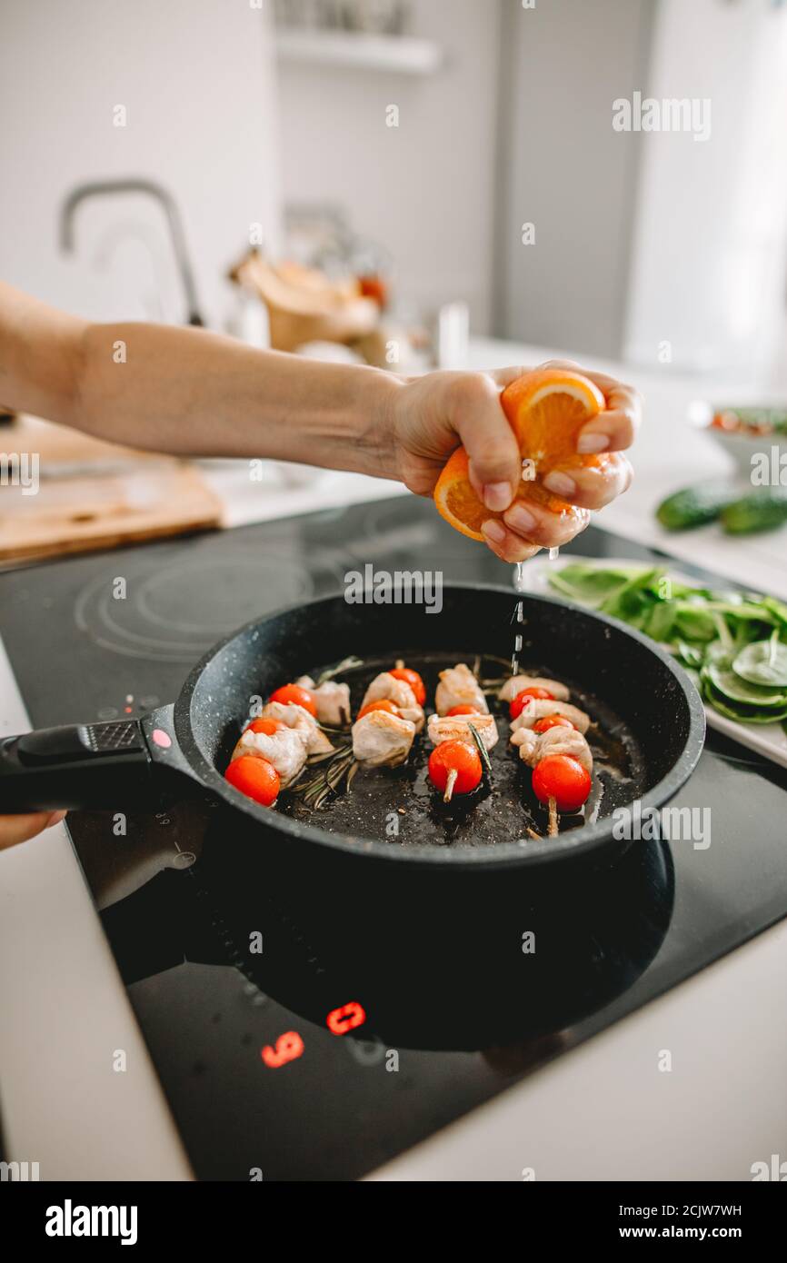 creative housewife imparting a flavour to food. process of preparing a ...