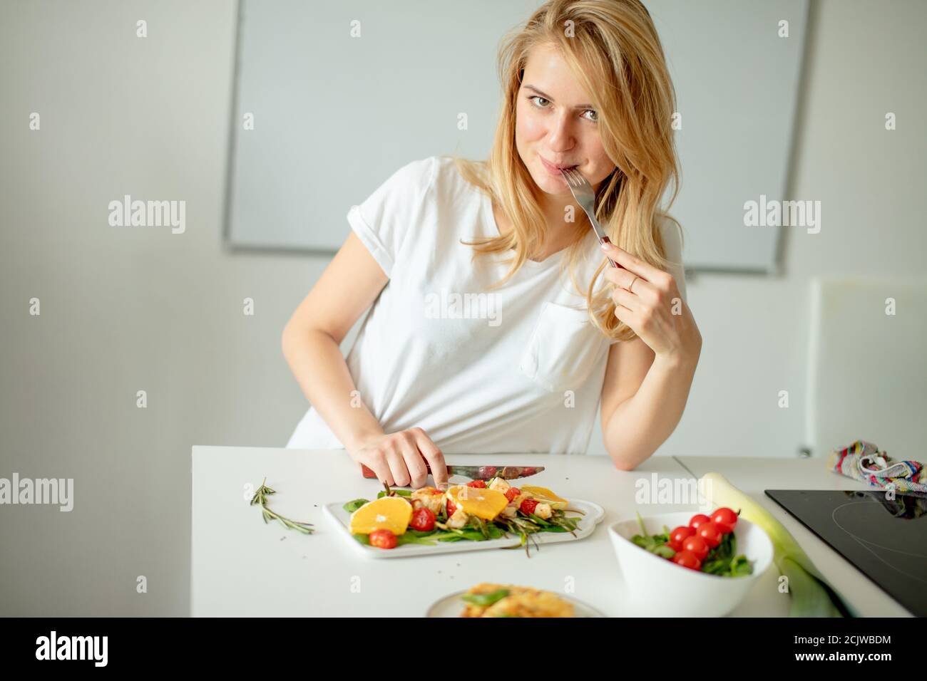 Beautiful girl is tasting food in the kitchen. close up photo Stock ...
