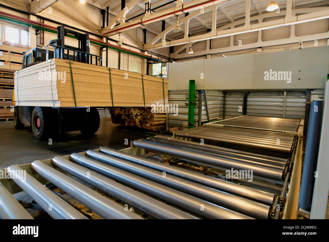 forklift load panels on automatic loader - furniture plant Stock Photo ...
