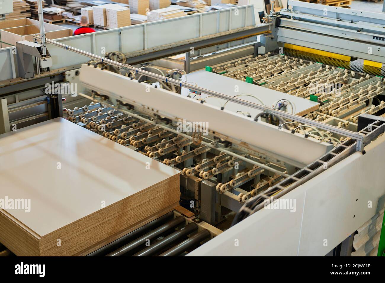 Machine load chipboard parts in furniture factory workshop Stock Photo ...