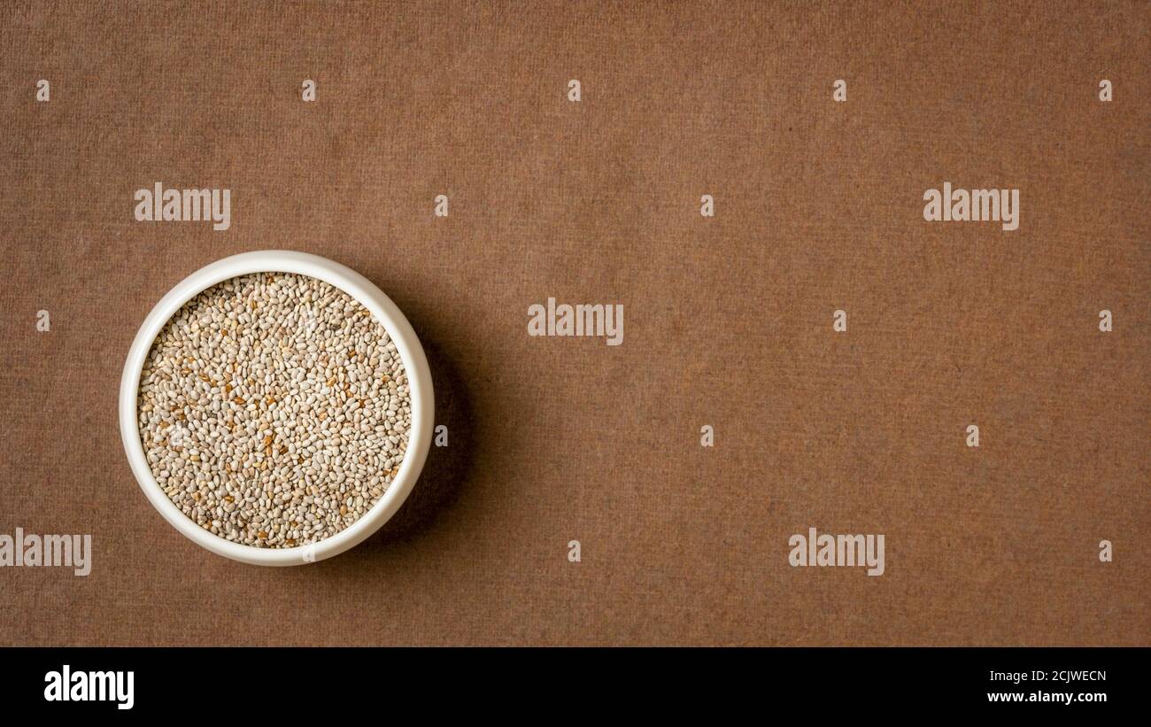 organic white chia seeds rich in omega-3 fatty acids, a small ceramic ...