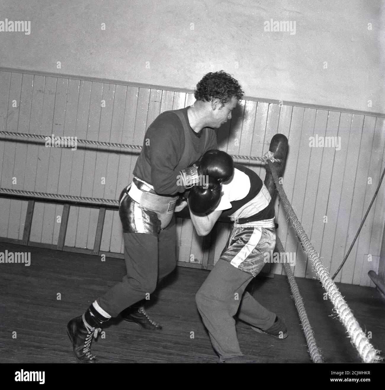 1960s, historical, two male boxers in a rig boxing at a youth club ...