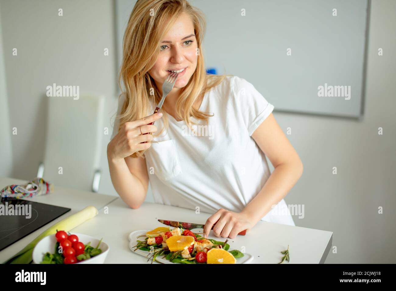 close up photo of good-looking pensive woman with fork in the mouth ...