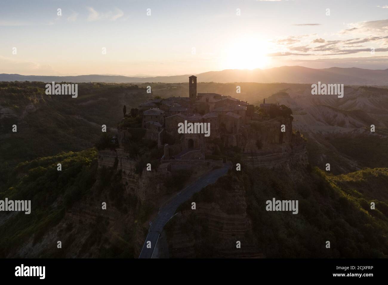 Aerial view of stone town Civita di Bagnoregio with the sun at the ...