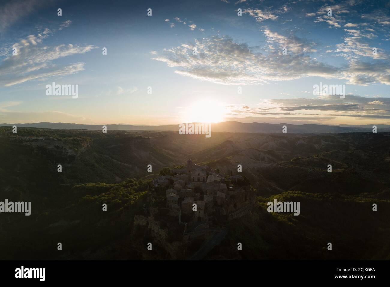 Aerial view of stone town Civita di Bagnoregio with the sun at the ...