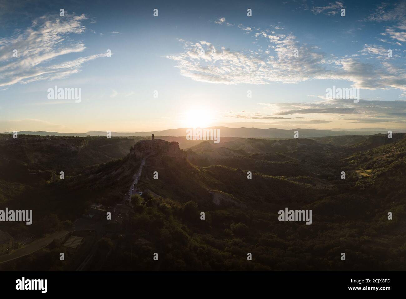 Aerial view of stone town Civita di Bagnoregio with the sun at the ...