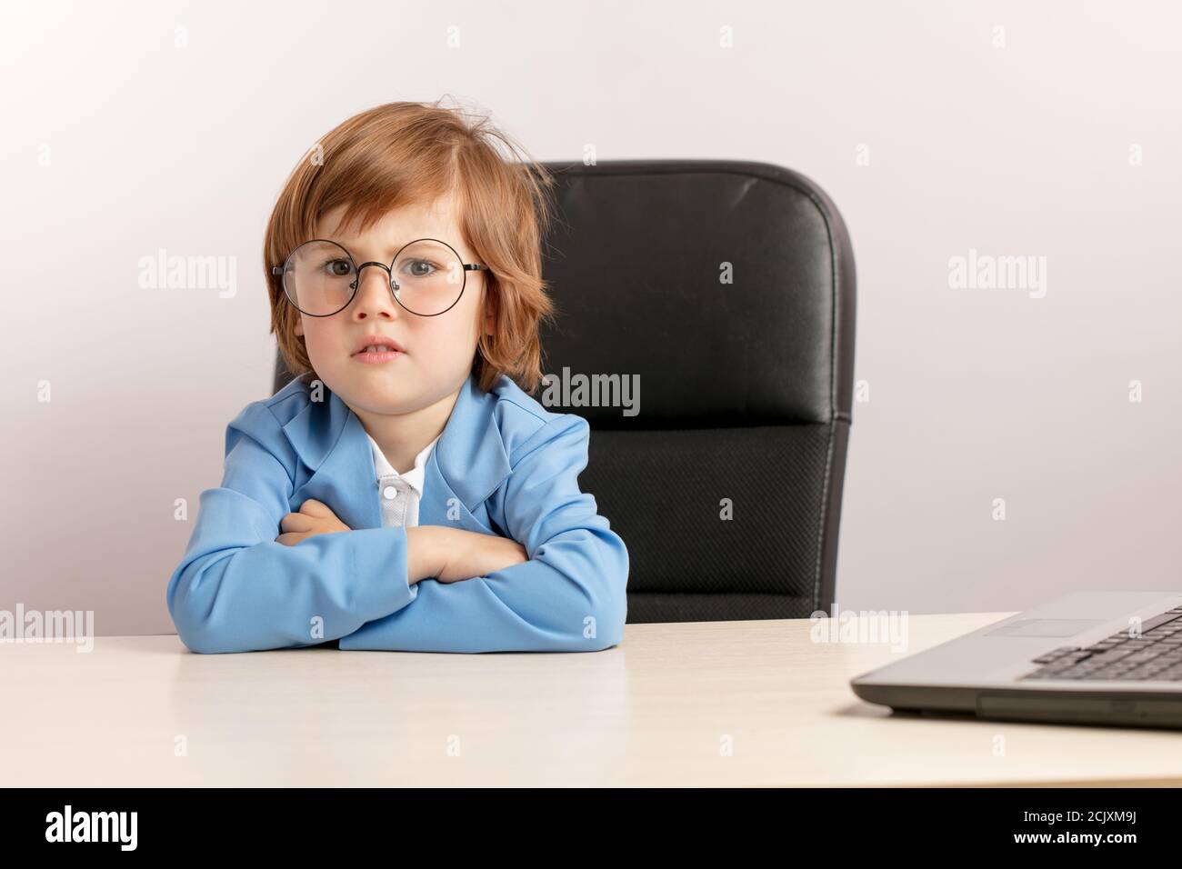 confident child folded his arms crossed in the studio. close-up photo ...