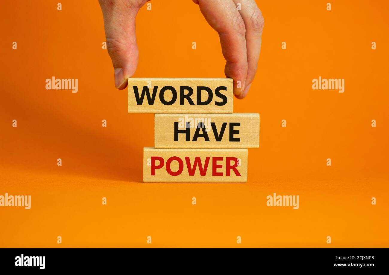 Male hand placing a block with word 'words' on top of a blocks tower ...