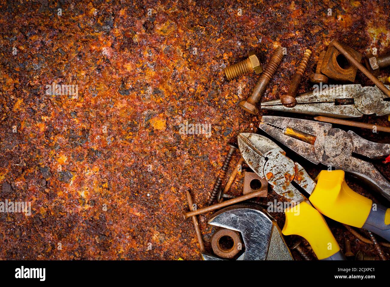 Tools, bolts,nails and nuts on a rusty metallic background with space ...
