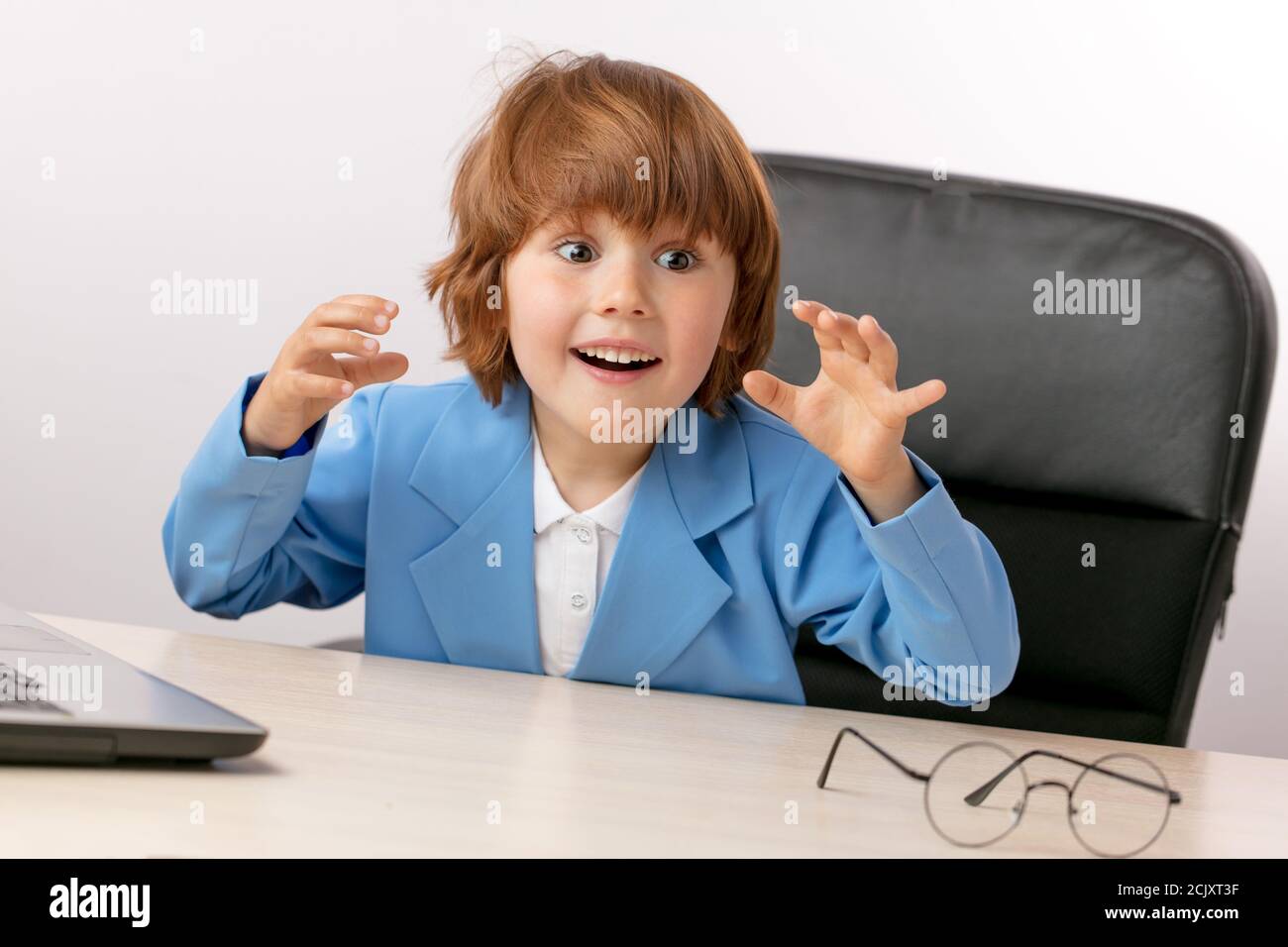 emotional handsome kid showing something using gestures while sitting ...
