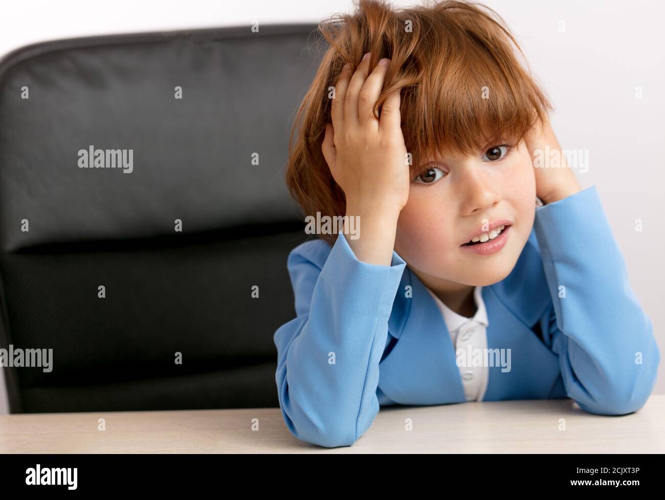 Portrait of boy sitting on red chair hi-res stock photography and ...