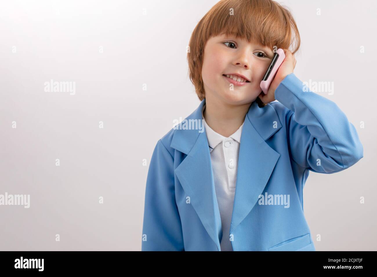 good looking red-haired kid is having a conversation on the phone Stock ...