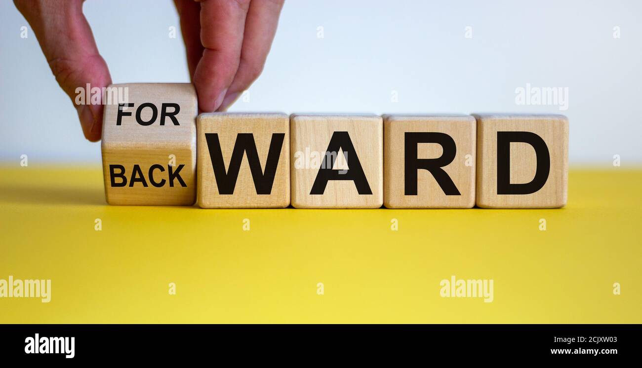 Hand turns a cube and changes the word 'backward' to 'forward' on ...