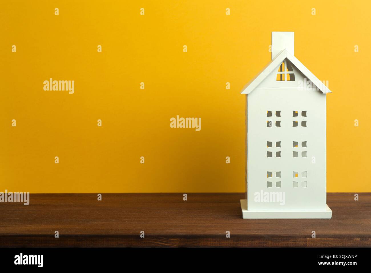 Toy house on yellow background. Real estate, rental housing and house ...