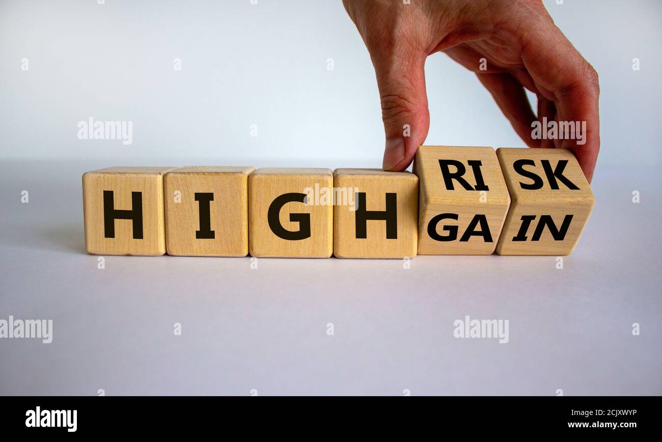 Cube form the expression 'high risk, high gain'. Male hand. Beautiful ...