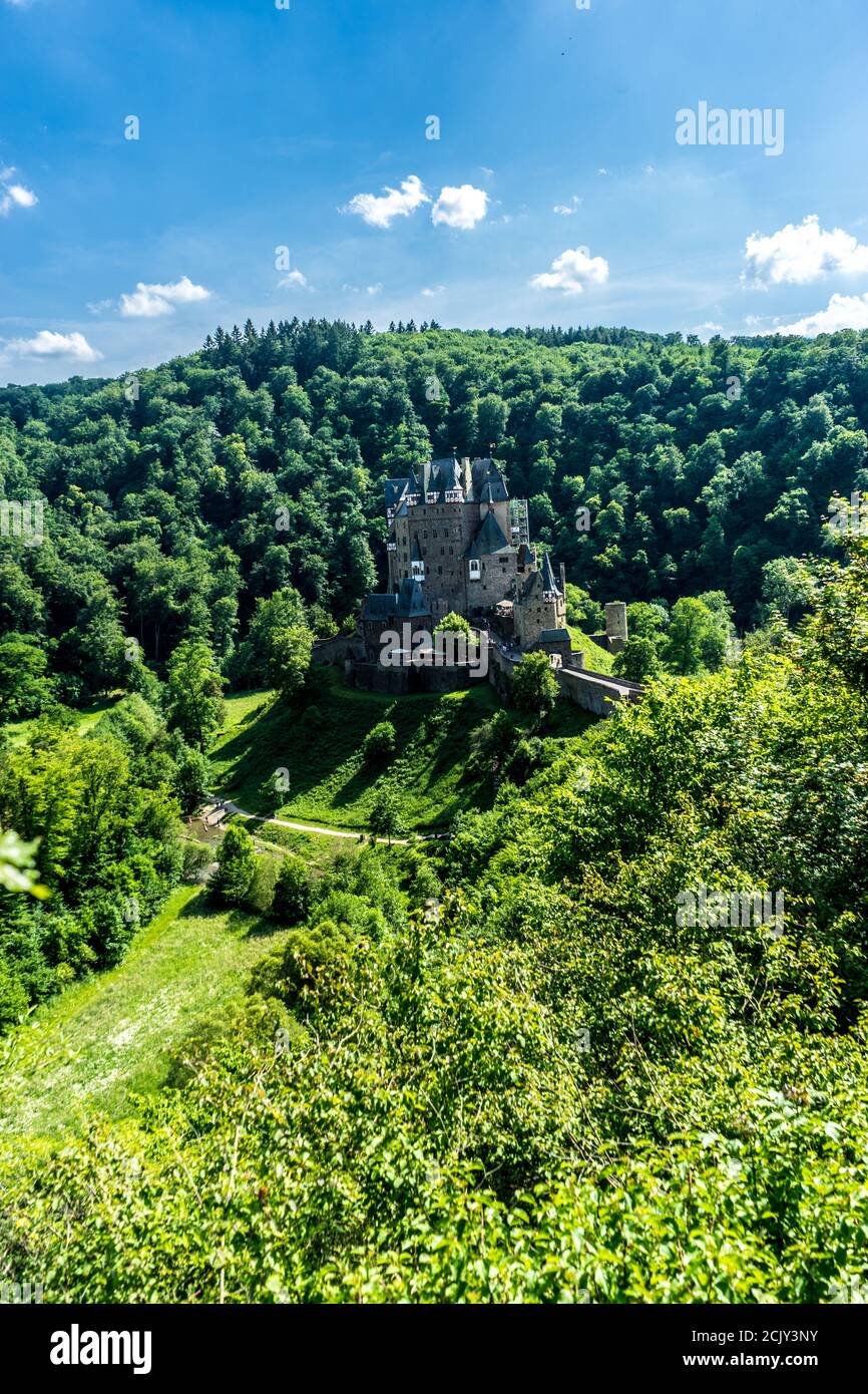 Beautiful vertical shot of the Eltz Castle surrounded by trees in ...