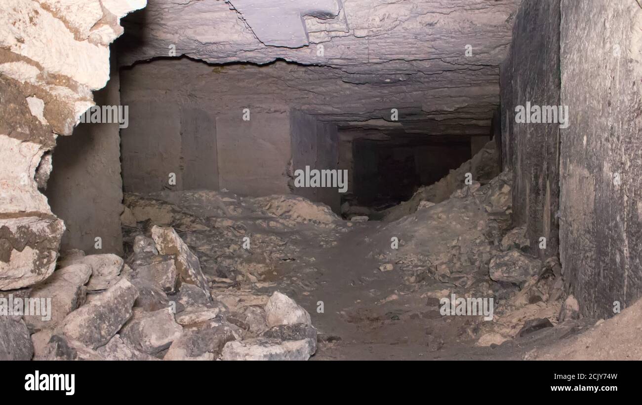 Old underground passage, dungeon, catacombs lined with stones ...