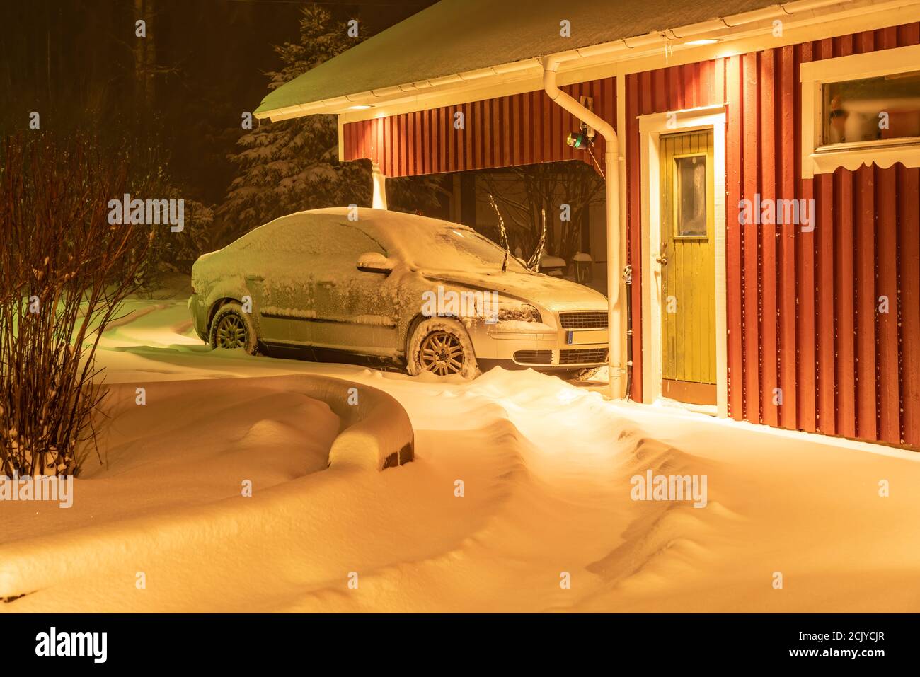 Silver colored car covered with much fresh snow afer snowfall. Parking ...