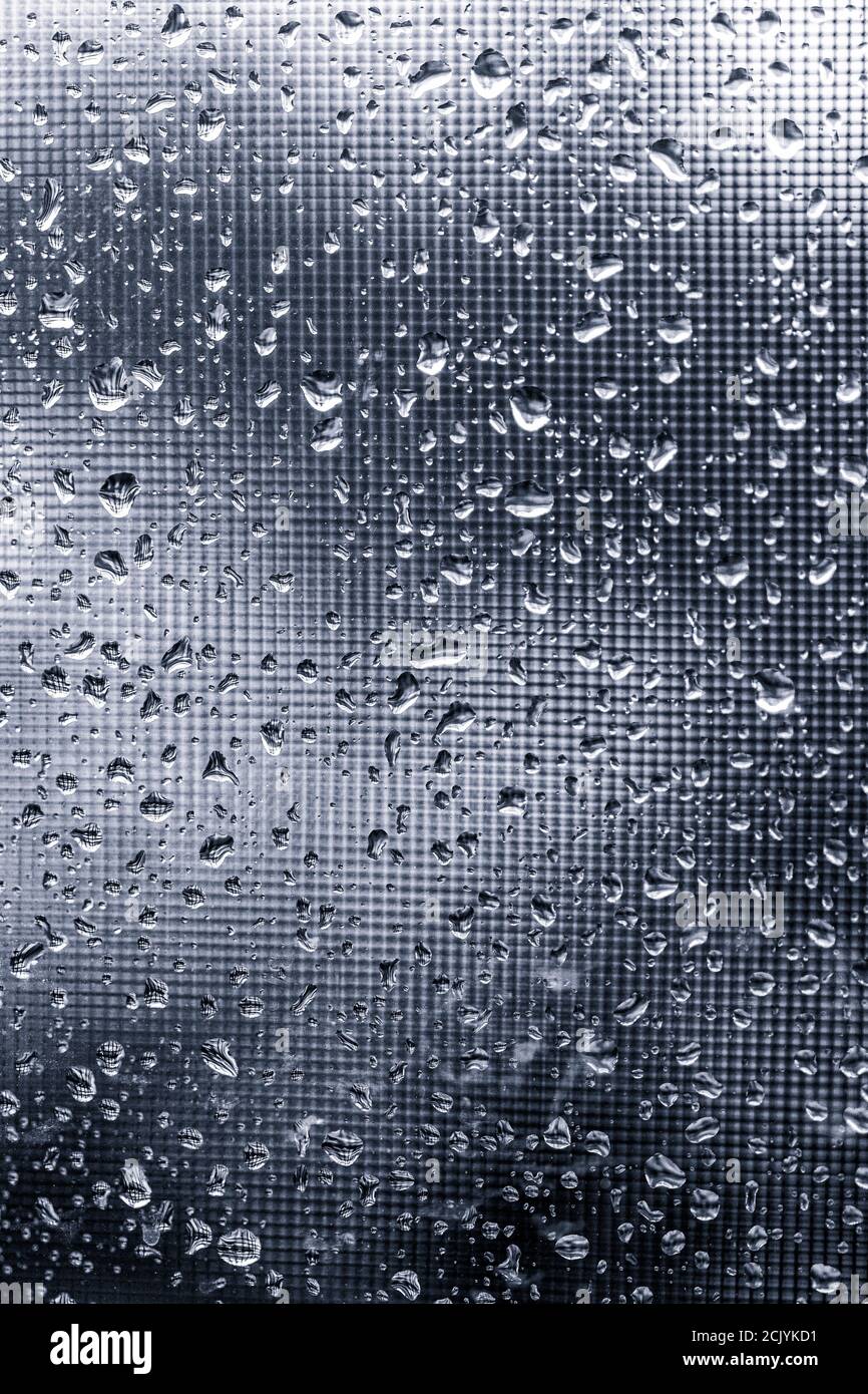 Raindrops collect on a window Stock Photo - Alamy
