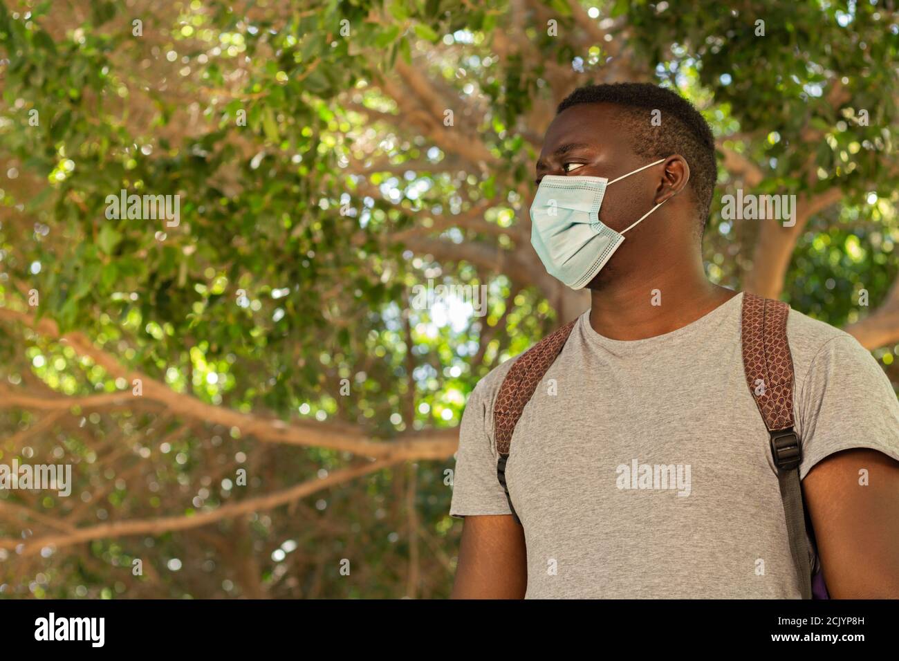 Black male wearing a protective mask outdoors - pandemic concept Stock ...