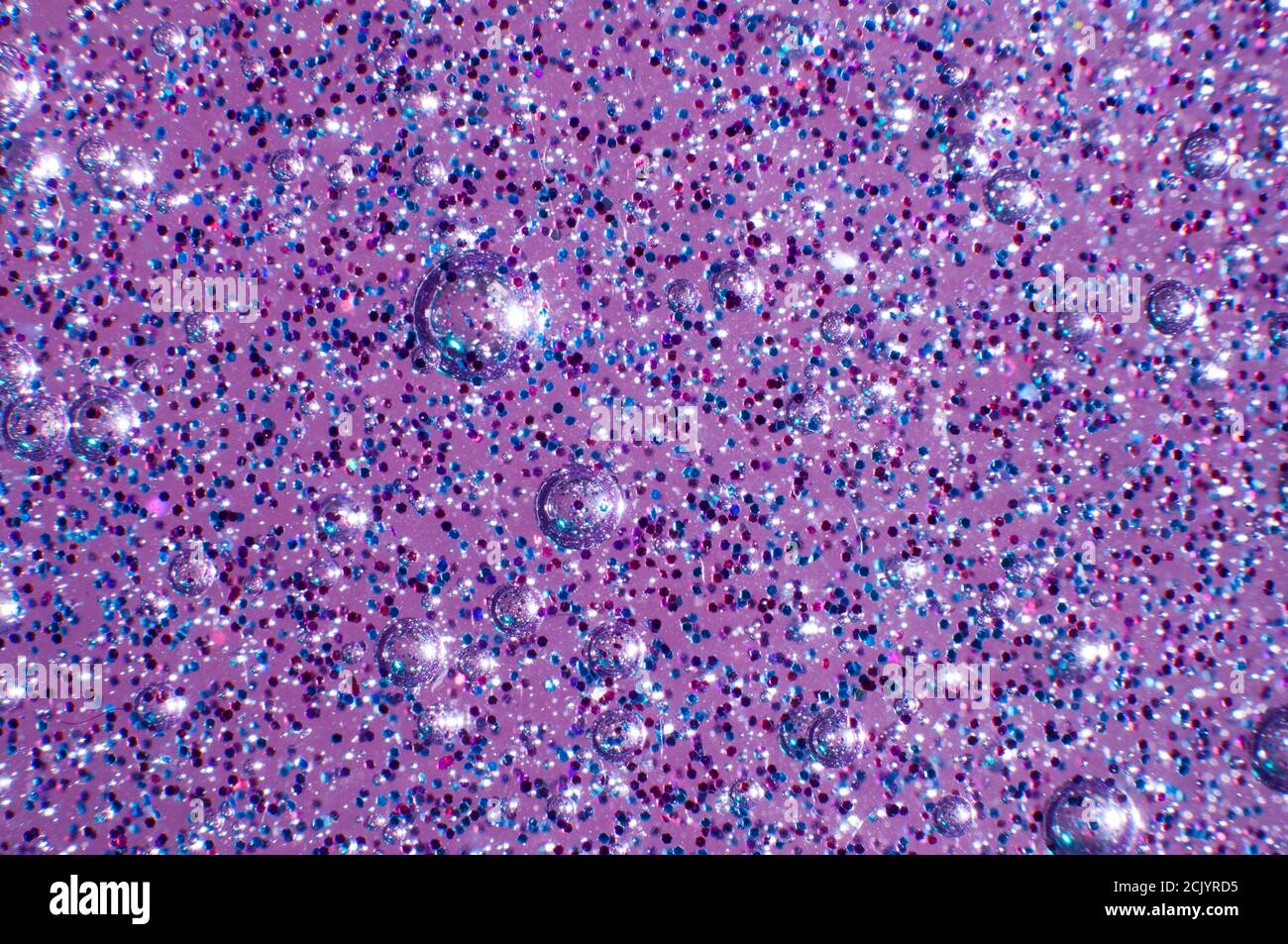 Macro of transparent glowing slime with glittering particles and ...