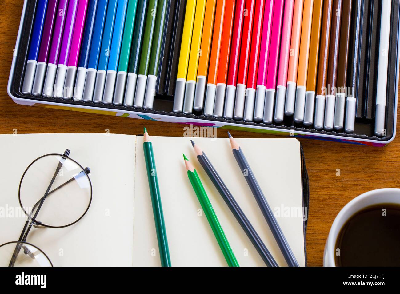 Drawing and painting table, sketching pencils and sketchbook, empty ...