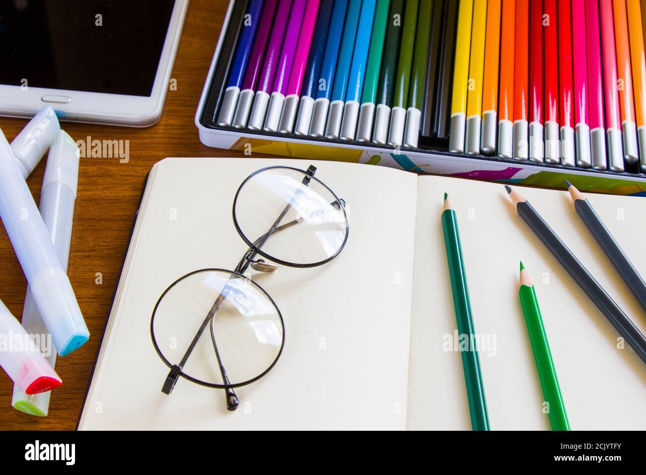 Drawing and painting table, sketching pencils and sketchbook, empty ...