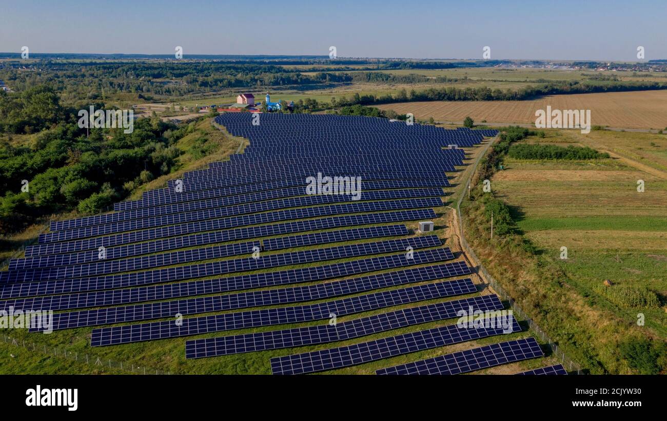 Solar Power Station in Green Field on Sunny day. Aerial view. Solar ...