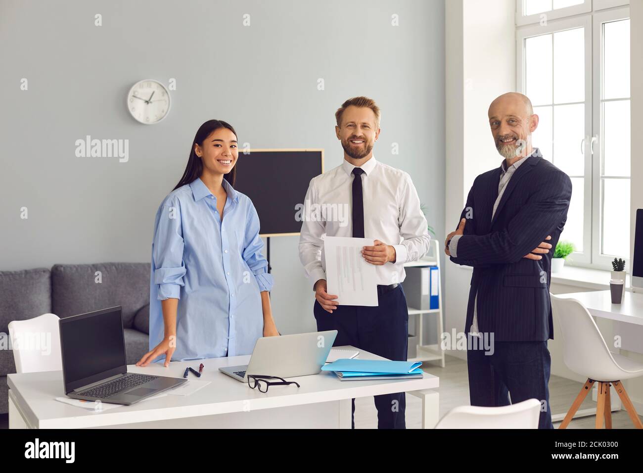Happy staff of company Marketing Department standing together in office ...