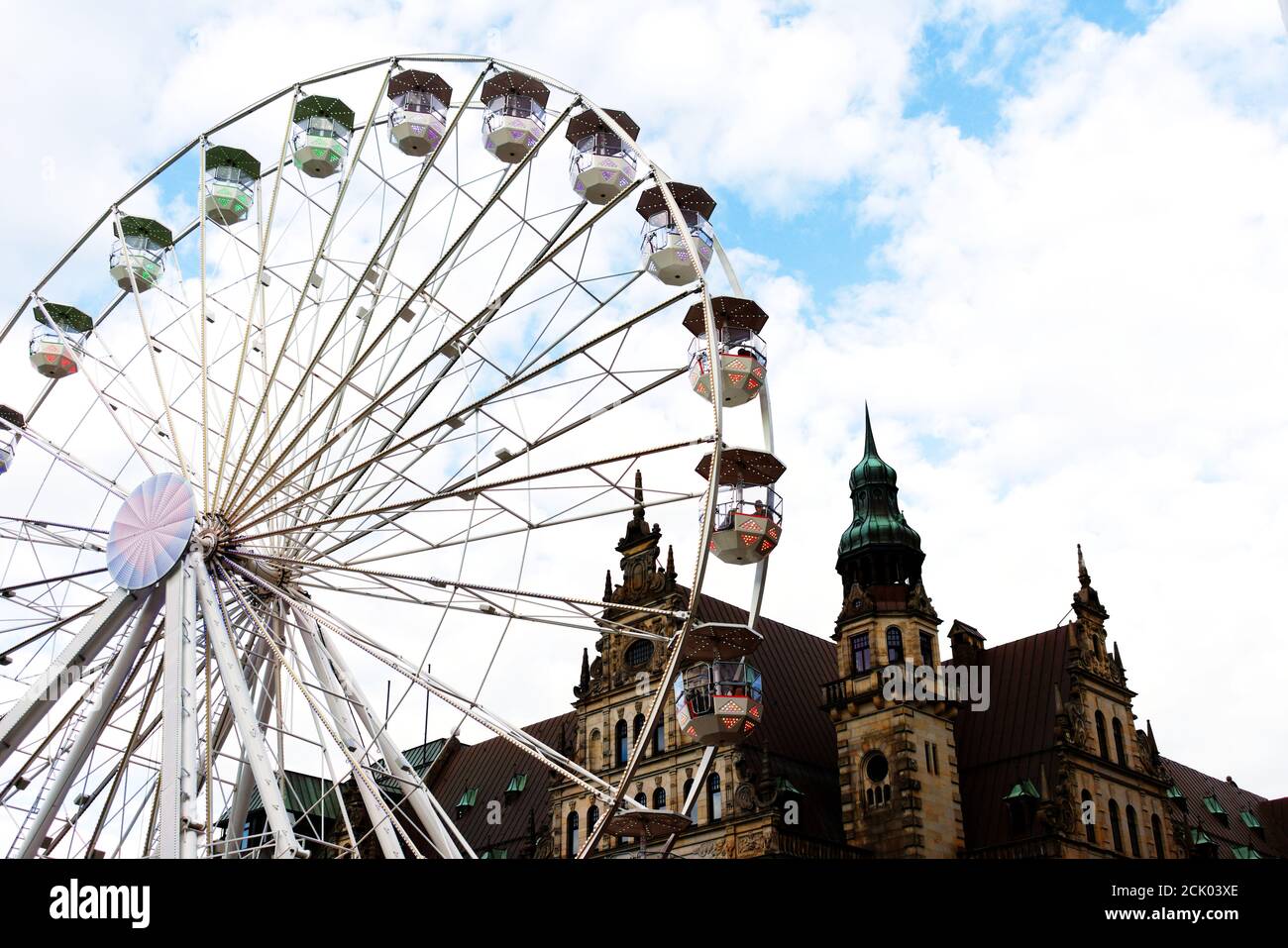 a colourful Ferris wheel in front of a historical building at Bremen ...