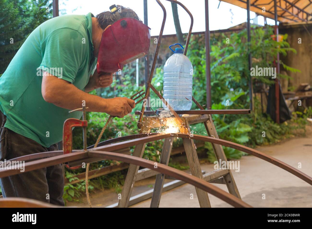 Human working of welding. Lights, manual. welder is welding metal part ...