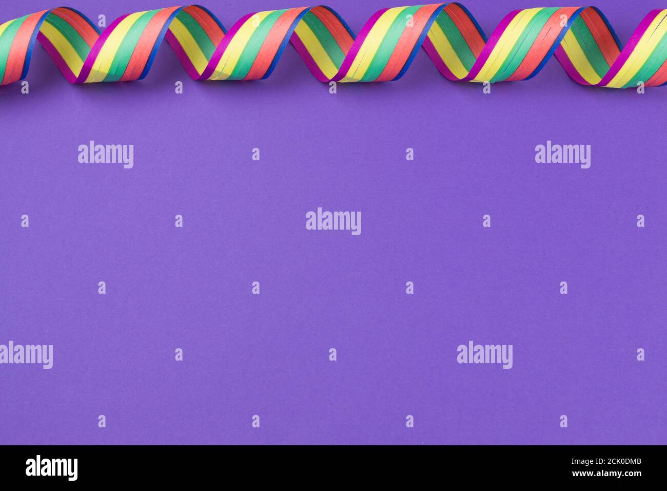 Streamers on a purple background with copy space Stock Photo - Alamy